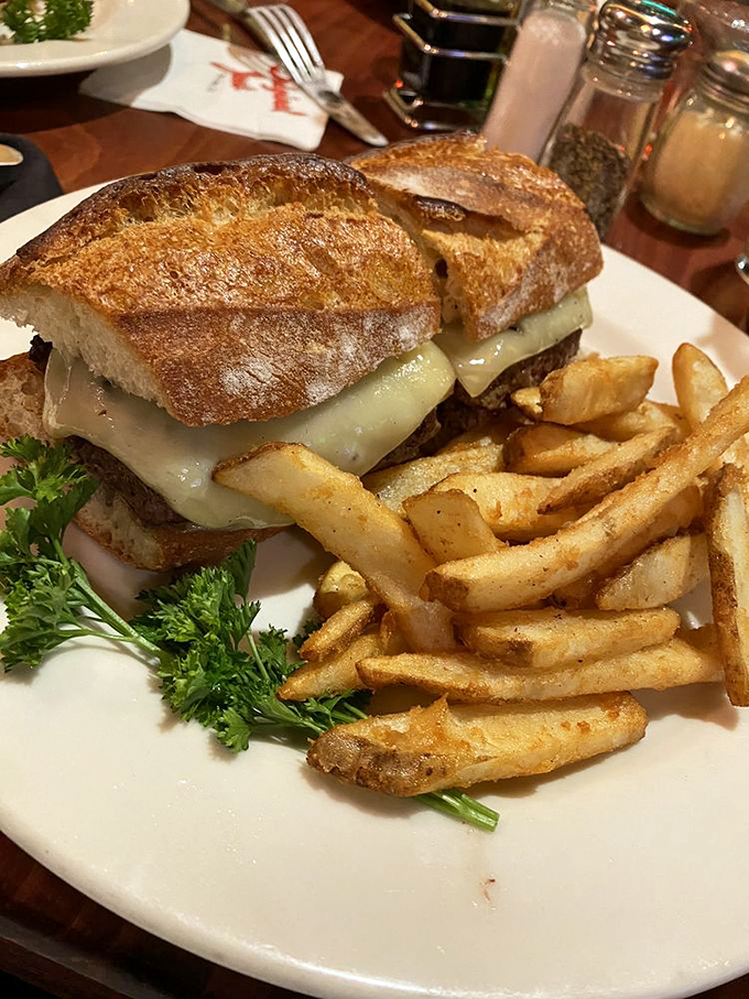 Not all heroes wear capes – some come on artisanal bread with melted cheese, accompanied by golden fries that crunch like autumn leaves.