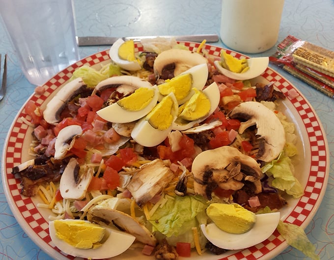 A chef salad that doesn't skimp on the good stuff. Those perfectly halved eggs are practically winking at you from the plate.