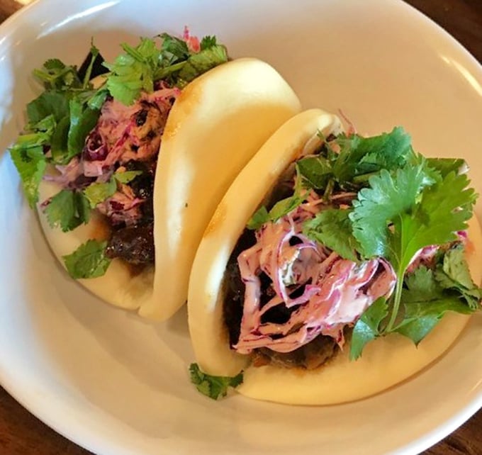 Pillowy bao buns cradle savory fillings and bright herbs – like edible clouds carrying flavor payloads straight to your happiness center.