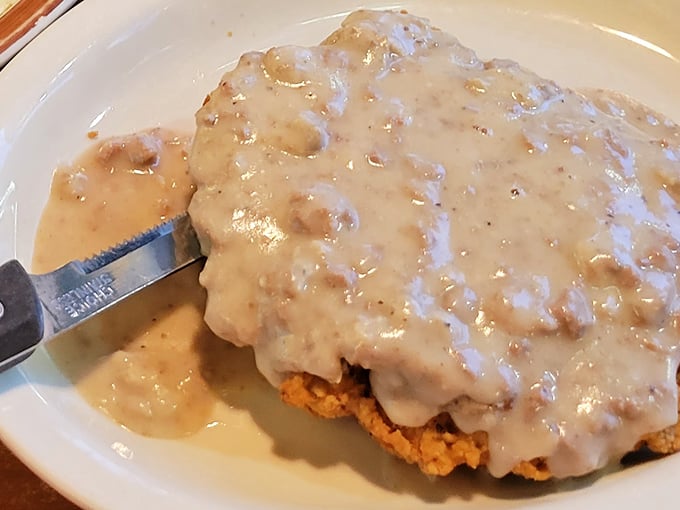 Country fried steak swimming in peppery gravy—proof that sometimes the most beautiful things in life are completely smothered.
