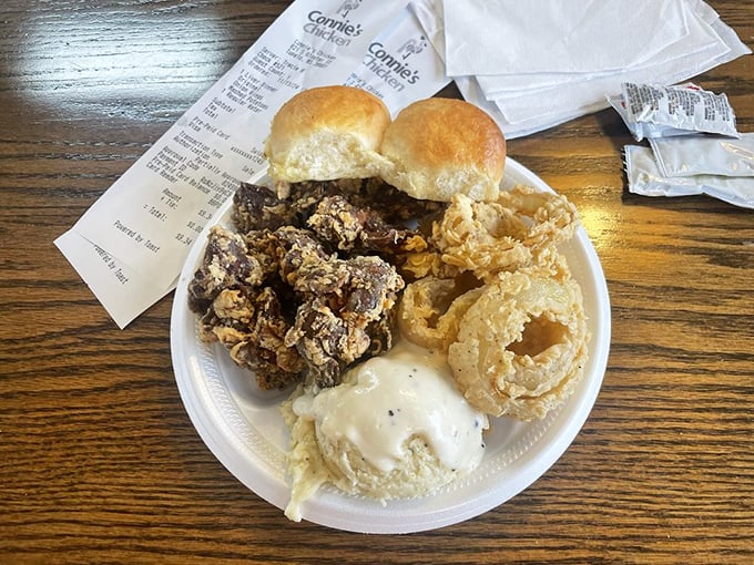A plate that doesn't mess around—fried chicken livers, onion rings, and rolls that would make your grandmother nod in silent approval.
