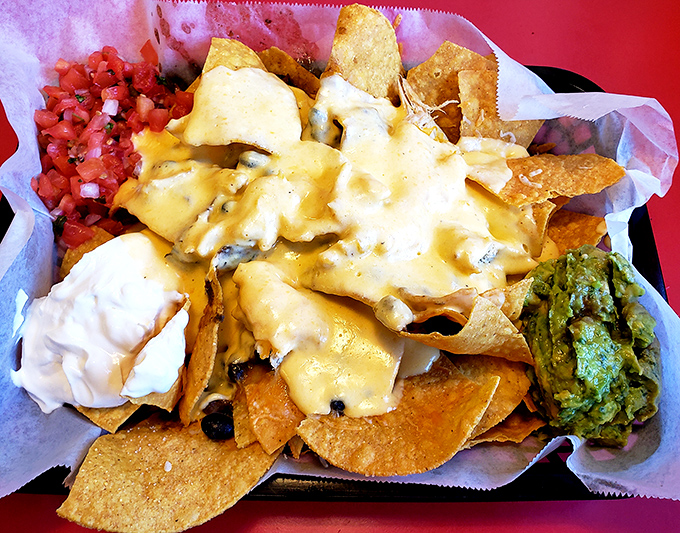 These loaded nachos aren't just a snack—they're an architectural marvel of cheese, chips, and happiness that demands to be shared.