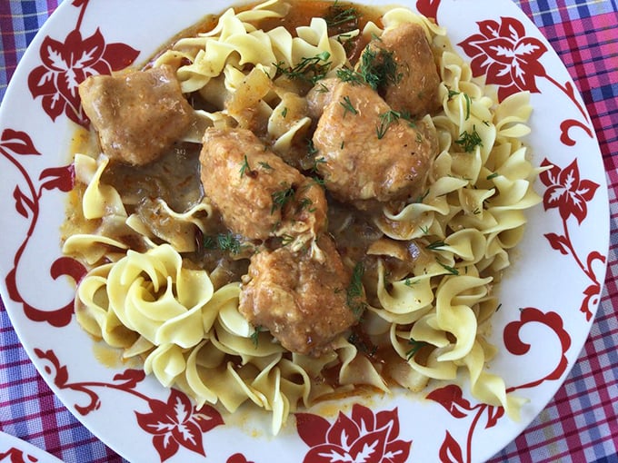 Chicken paprikash over homemade noodles – where tender meat meets silky sauce. This isn't dinner; it's a warm hug from a faraway homeland.