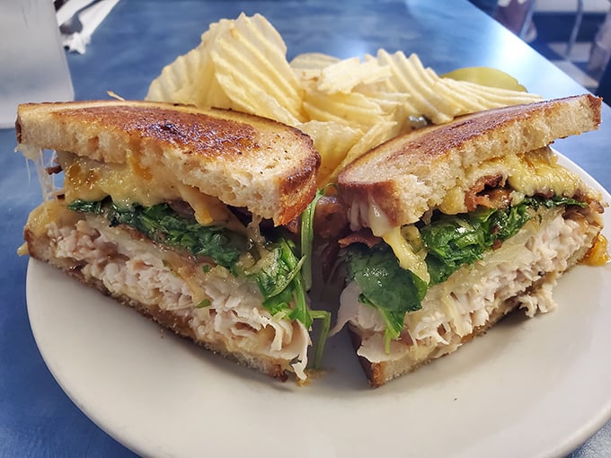 The architectural marvel of this sandwich – perfectly toasted bread, layers of chicken, cheese, and greens – would make Frank Lloyd Wright weep with joy.