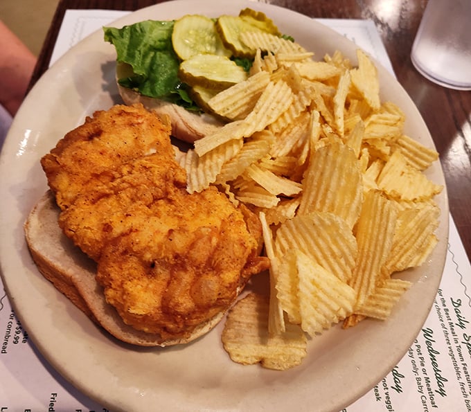 Crispy meets juicy in this chicken sandwich that doesn't need fancy aioli or artisanal bread to deliver pure satisfaction – just honest cooking.