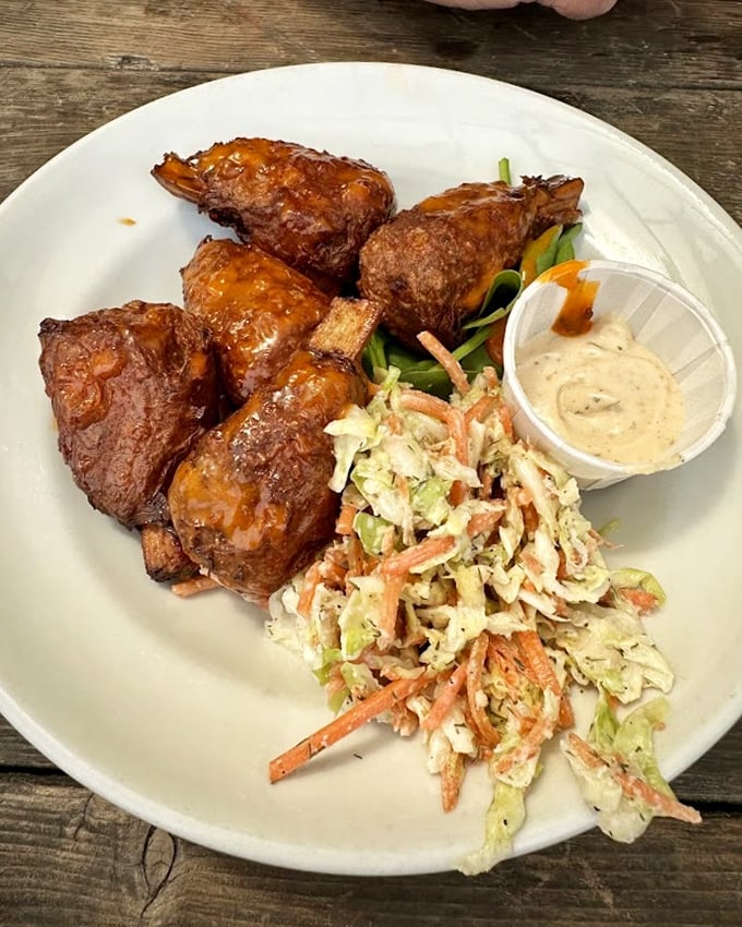 These saucy beauties glisten with potential, accompanied by fresh slaw that adds crunch to every bite—a flavor party on a plate.
