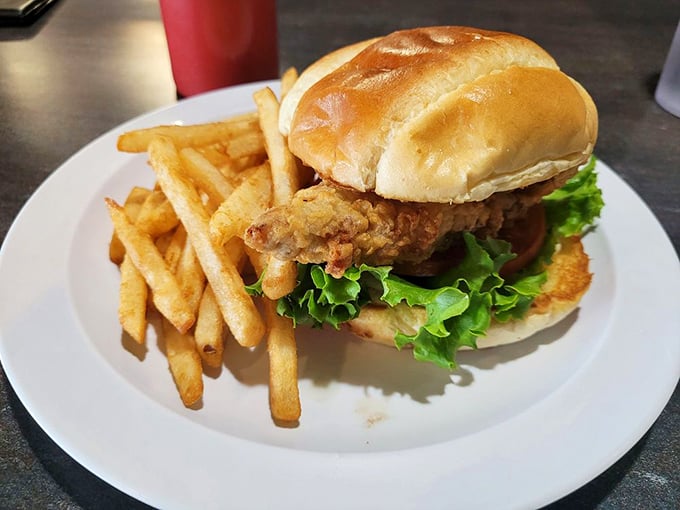 This isn't just a sandwich; it's architectural genius—crispy chicken fried steak balanced with fresh lettuce on a pillowy bun.