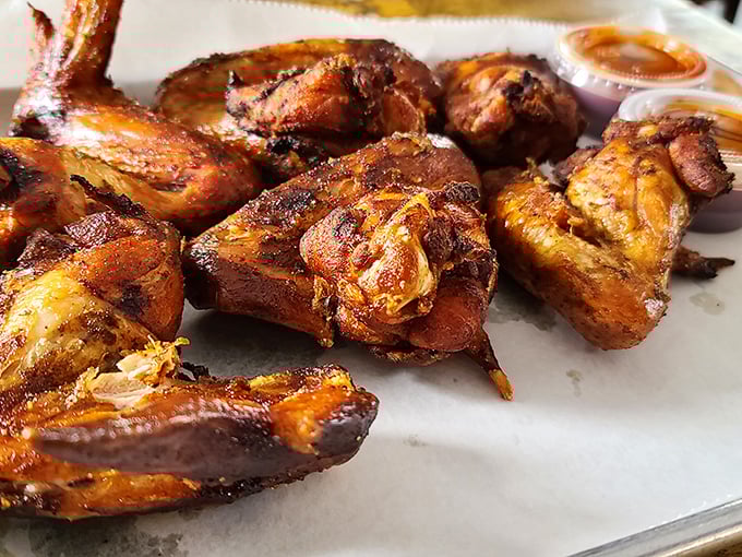 Smoked wings with skin crackling like nature's candy—proof that chickens didn't evolve just to cross roads, but to be smoked to perfection at Woodyard.