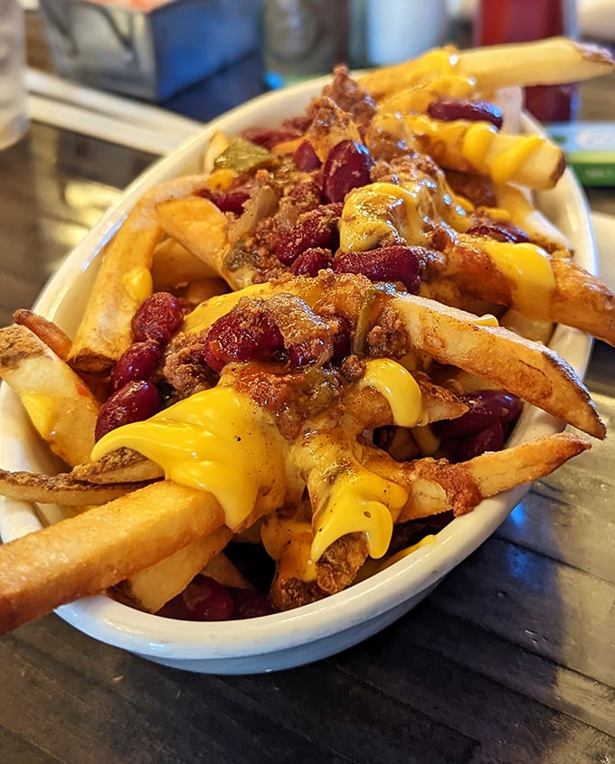 These aren't just chili cheese fries – they're a commitment, a relationship, and possibly the reason stretchy pants were invented.