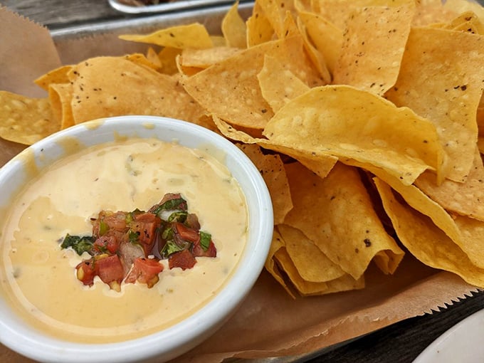 Queso with pico de gallo and tortilla chips – because sometimes you need a brief intermission between acts of meat consumption.