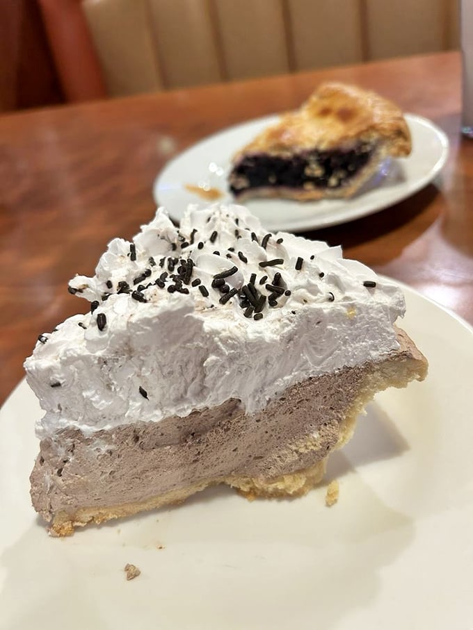 Chocolate cream pie with a mountain of whipped cream—proof that sometimes the best things in life haven't changed since your grandparents' first date.