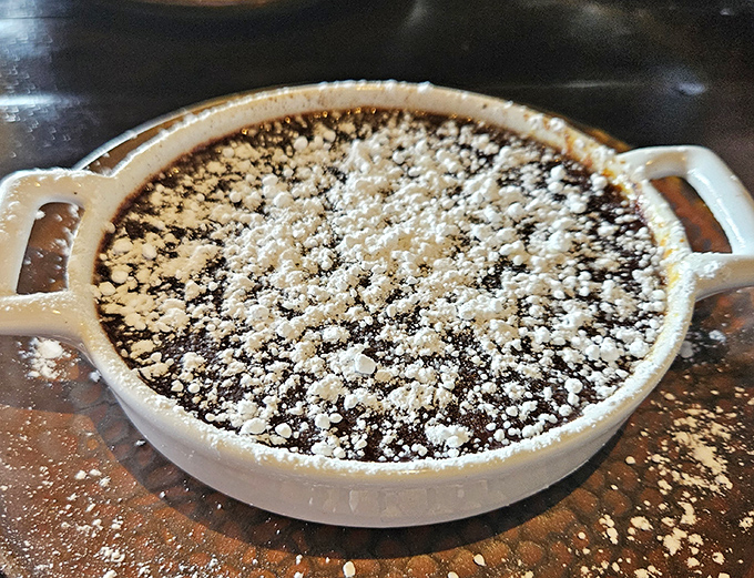 This chocolate crème brûlée isn't just baked—it's been dusted with powdered sugar like the first snow of winter. Crack that top with childlike glee!