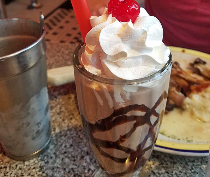 This chocolate malt isn't just a dessert—it's a commitment. Thick enough to bend your straw, with whipped cream that reaches heights requiring FAA clearance.