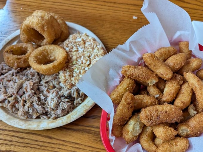 The classic chopped barbecue plate with all the fixings—proof that happiness doesn't need to be complicated, just perfectly executed and served on a paper plate.