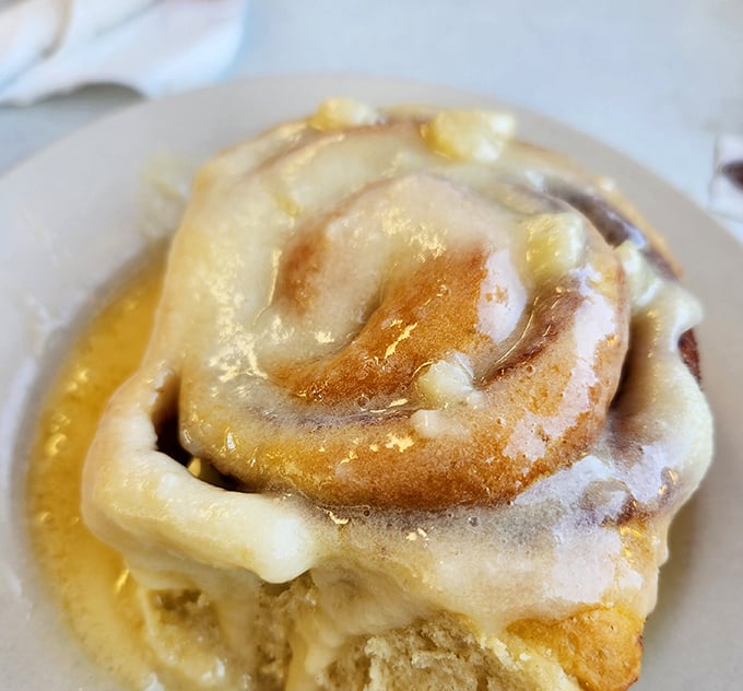 This cinnamon roll isn't just breakfast – it's dessert masquerading as morning food, with icing melting into every warm, cinnamon-spiced crevice.