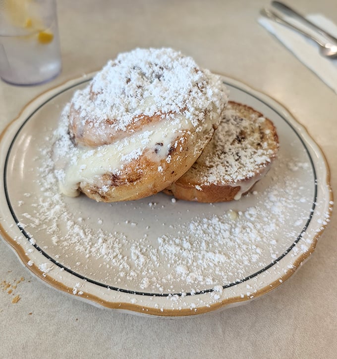 The grilled cinnamon roll isn't just breakfast—it's dessert masquerading as a morning meal, complete with cream cheese frosting.