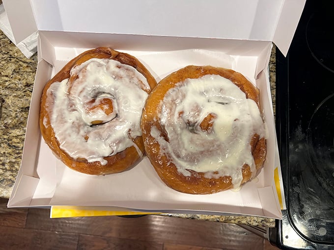Cinnamon rolls frosted to perfection—the spiral pattern hypnotizing you into believing calories don't count before 10 AM.
