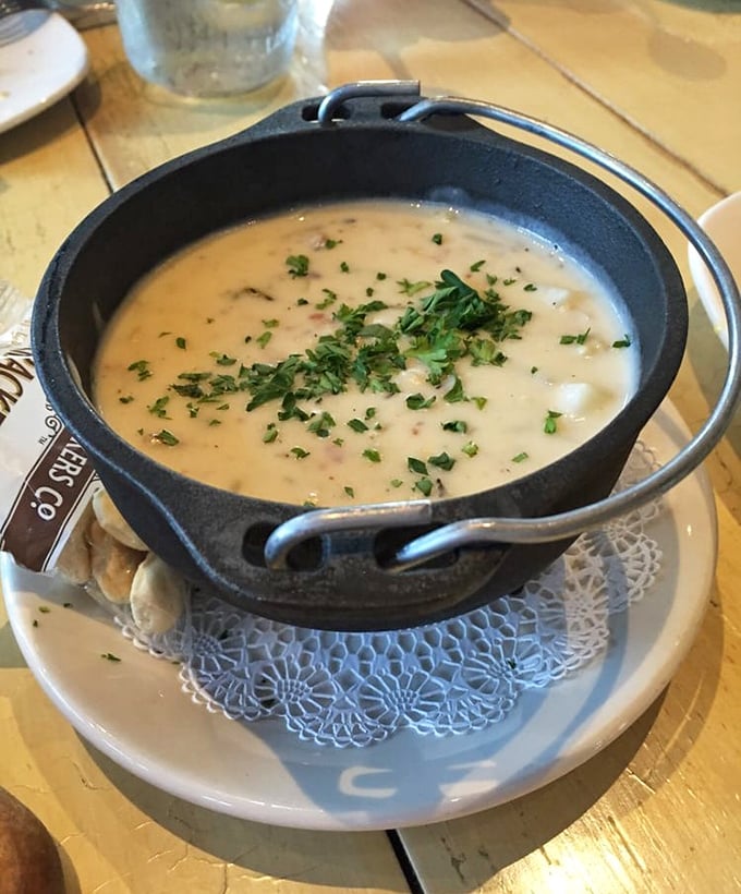 The clam chowder arrives in its own little cauldron, creamy and herb-flecked – New England comfort food that found a happy home in the Midwest.