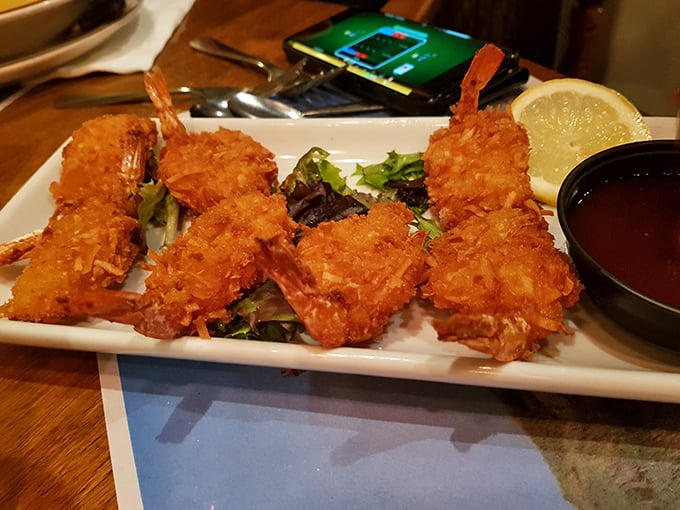 Coconut shrimp that crunch like autumn leaves—sweet, savory, and served with a dipping sauce worth bottling.