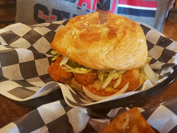 A sandwich that requires both hands and your full attention—crispy fish nestled in a pillowy bun that's worth every delicious, messy bite.
