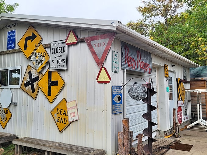 A building that's clearly taken the "road less traveled" quite literally. These salvaged street signs point to nowhere and everywhere at once.
