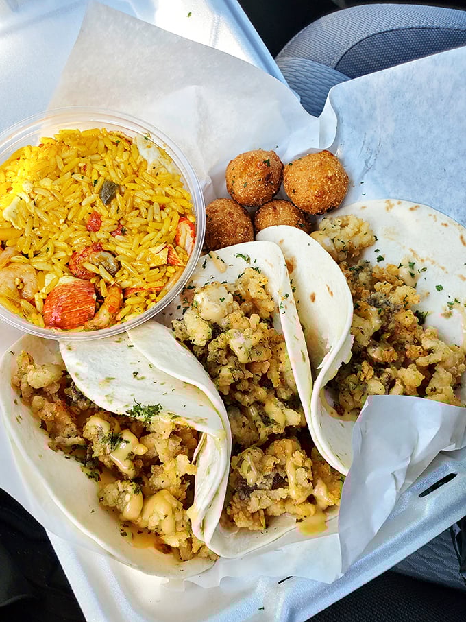 Seafood tacos and yellow rice—proof that sometimes the best ocean views come on a paper-lined tray rather than from an expensive beachfront restaurant. 