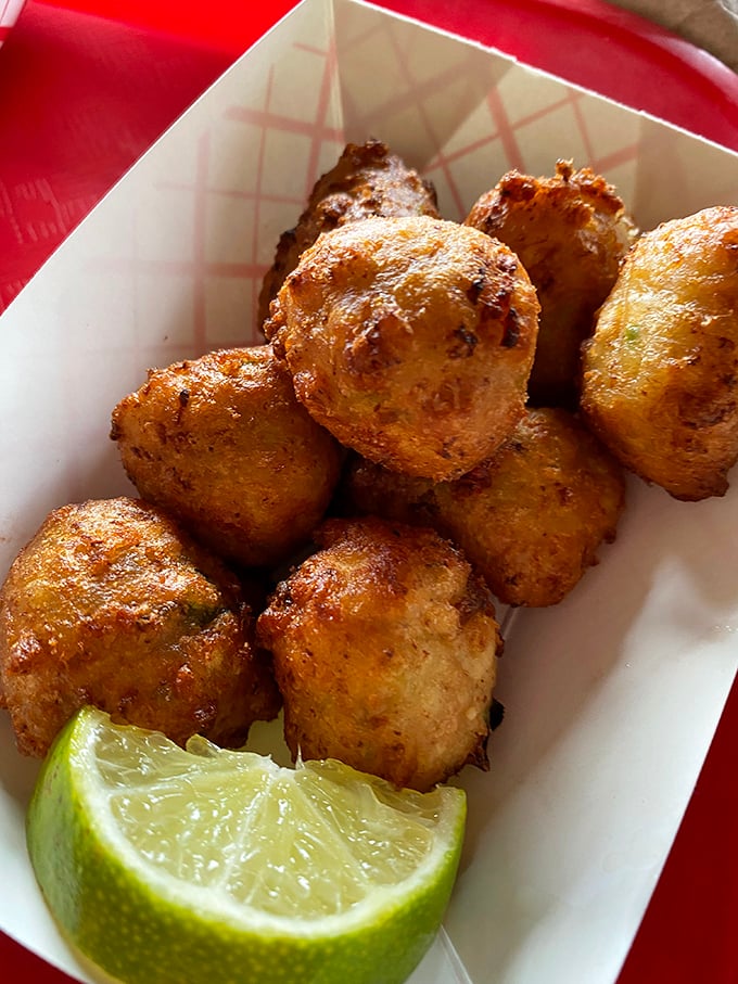 These conch fritters are the spherical ambassadors of Florida cuisine—crispy outside, tender inside, and completely irresistible with that lime squeeze.