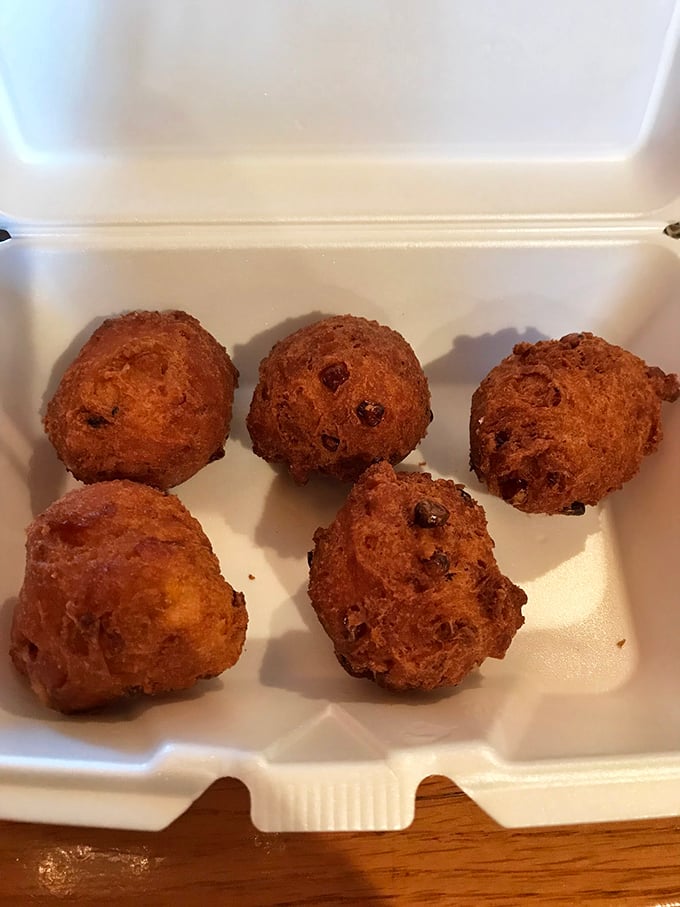 Corn fritters that look like edible gold nuggets—crispy, sweet, savory treasures that somehow improve everything they're served alongside.