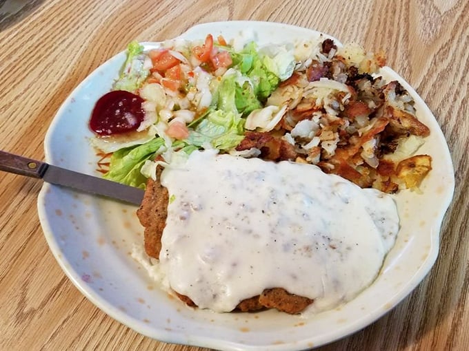 Country fried steak swimming in peppery gravy—the kind of dish that makes you want to hug the cook and thank them for not counting calories.