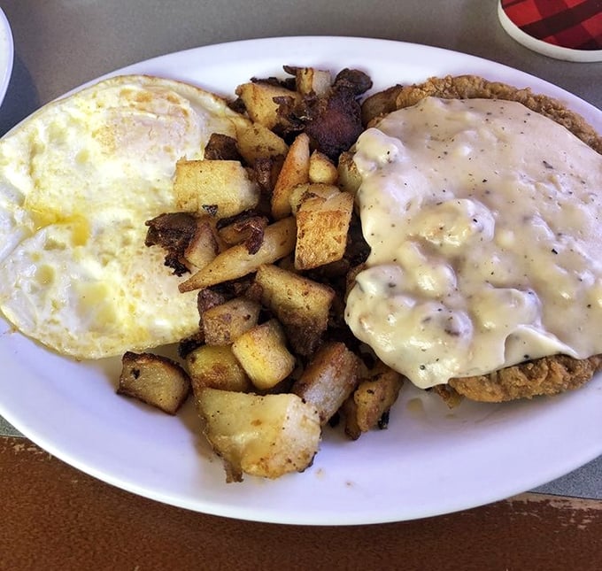 Country fried steak with eggs and potatoes – the breakfast equivalent of a warm hug from your favorite aunt who never counted calories.