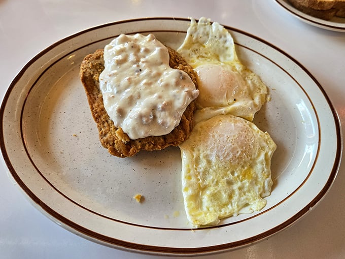 Country fried steak with creamy gravy alongside sunny eggs—the breakfast equivalent of a warm hug after a long night.