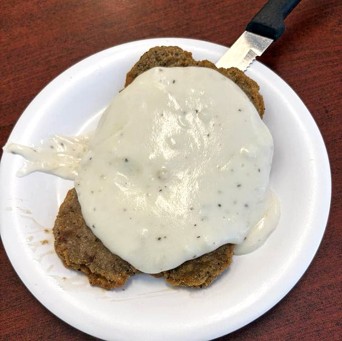 Country fried steak smothered in gravy so good you'll contemplate drinking it like a soup when nobody's looking. Comfort food incarnate.