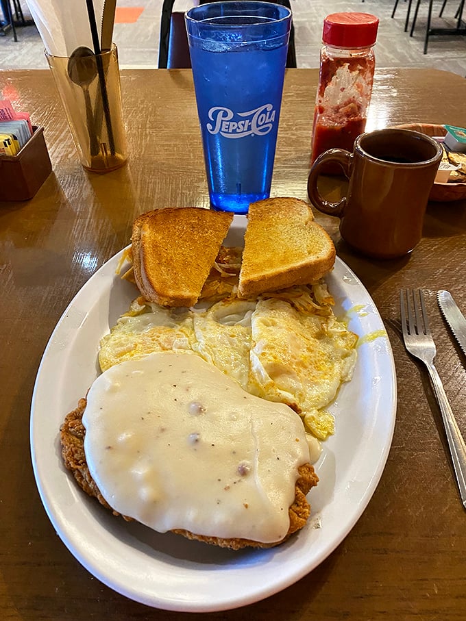Country fried steak with gravy, eggs, and toast—the breakfast equivalent of a warm blanket on a cold morning.