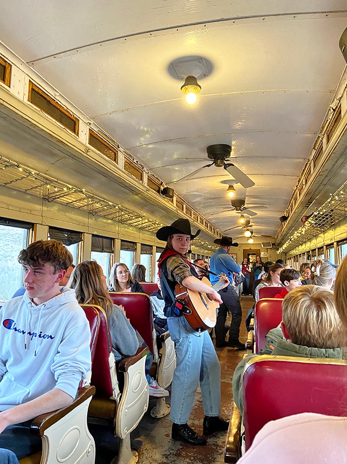Live music on the rails! Nothing says "authentic experience" like a cowboy with a guitar serenading you through mountain passes.