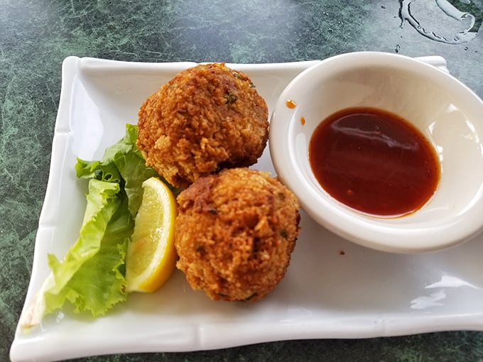 Crab balls that could make a seafood skeptic weep with joy – crispy outside, succulent inside, and served with a sauce that means business.