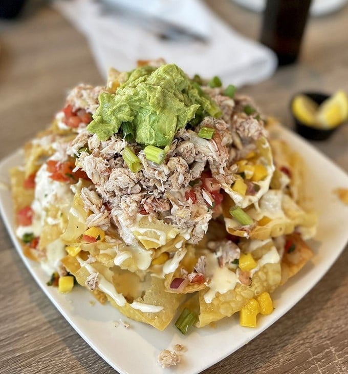 Crab nachos that defy gravity and good sense—a towering monument to the art of delicious excess.