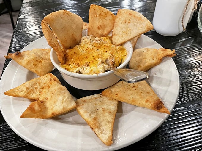 Hot crab dip surrounded by toasted pita points—the perfect shareable starter. Though "sharing" becomes questionable after the first heavenly bite.
