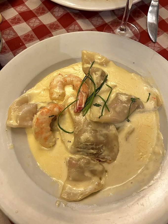 Seafood-stuffed ravioli swimming in cream sauce—proof that sometimes the most beautiful performances happen on a plate rather than a stage.