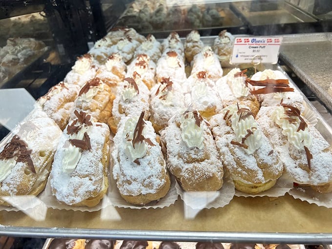 These cream puffs, dusted with powdered sugar and chocolate, aren't just desserts—they're little clouds of joy that make diets seem like a terrible idea.
