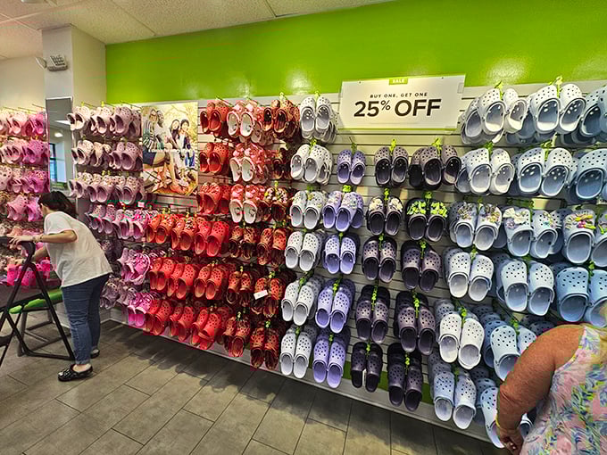 The wall of Crocs presents a rainbow of comfort possibilities—because nothing says "I've officially embraced vacation mode" like rubber footwear in every color of the sunset.