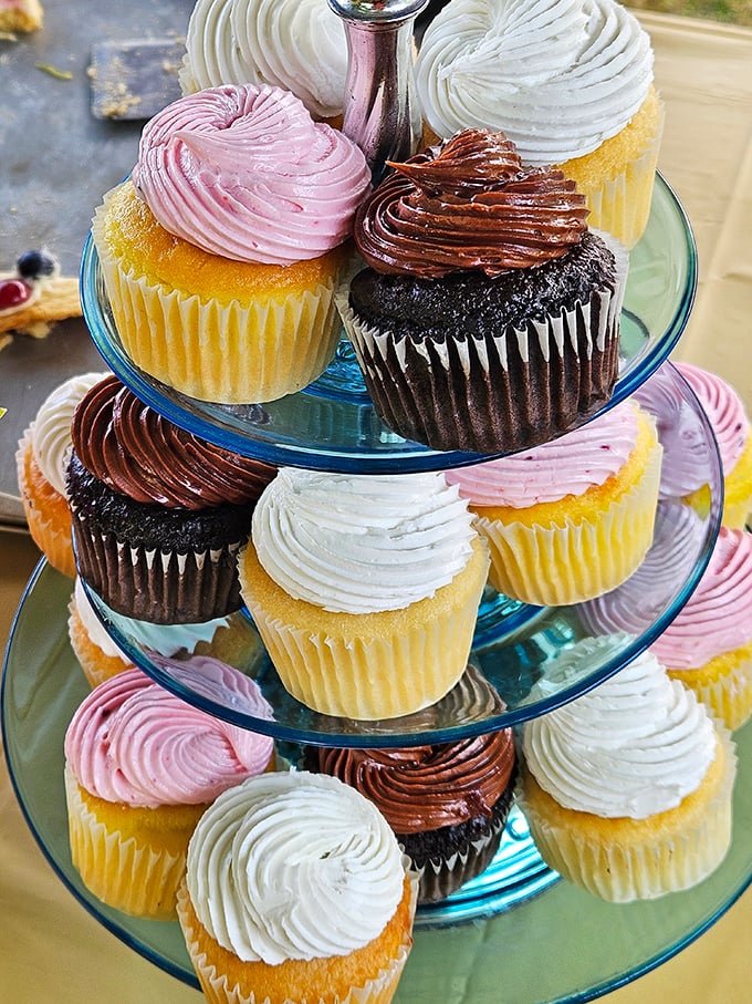 These cupcakes aren't just stacked—they're strategically tiered for maximum temptation. The pink ones are practically flirting with you.