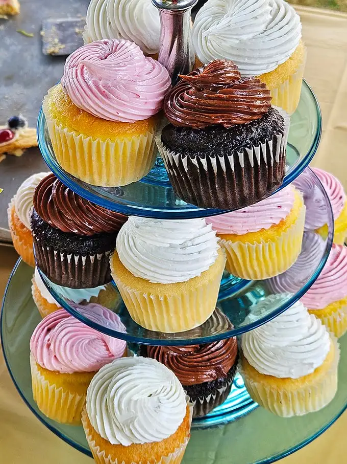 These cupcakes aren't just stacked—they're strategically tiered for maximum temptation. The pink ones are practically flirting with you.