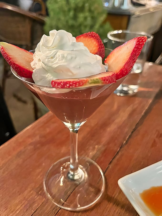 Fresh strawberries and whipped cream transform this cocktail glass into dessert territory—proof that Guerrera knows how to end a meal on a high note.