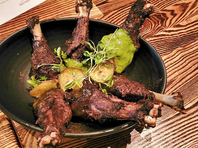 These duck wings redefine finger food—caramelized, crispy, and served with garnishes that make you forget chicken wings ever existed.