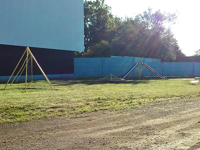 Those yellow swing sets aren't just playground equipment—they're time machines transporting kids between play and cinema magic.