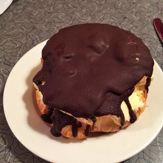This chocolate-topped pastry isn't just dessert—it's therapy on a plate, with a chocolate coating thick enough to require a commitment.