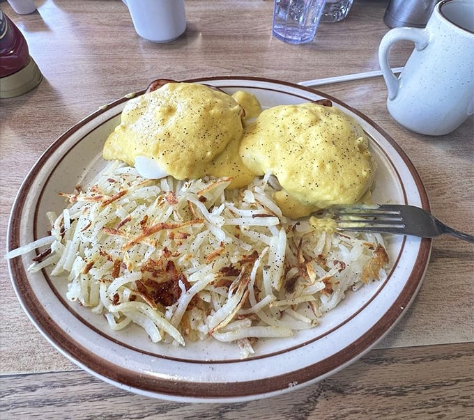 Eggs Benedict done right – where hollandaise sauce isn't just an ingredient, it's practically a religious experience with crispy hash browns as disciples.