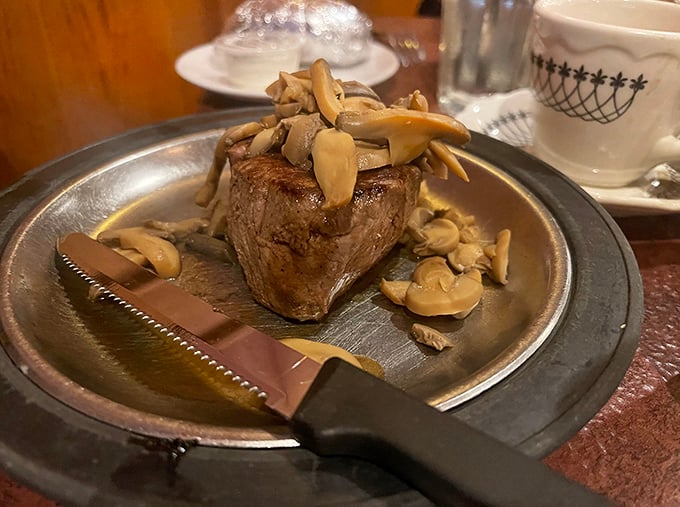 A filet mignon crowned with mushrooms that have found their purpose in life. That steak knife isn't just a utensil—it's a magic wand.