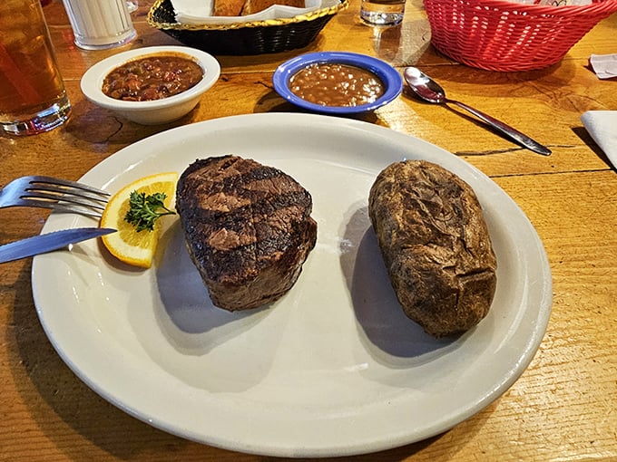 Filet mignon and a baked potato—the Fred Astaire and Ginger Rogers of steakhouse classics, dancing together in perfect harmony on a simple white plate.