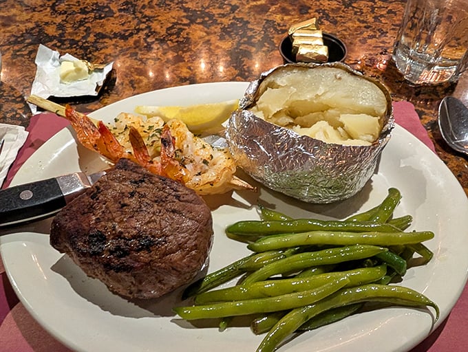 Filet mignon, baked potato, and fresh green beans—the holy trinity of steakhouse dining that never disappoints the faithful.